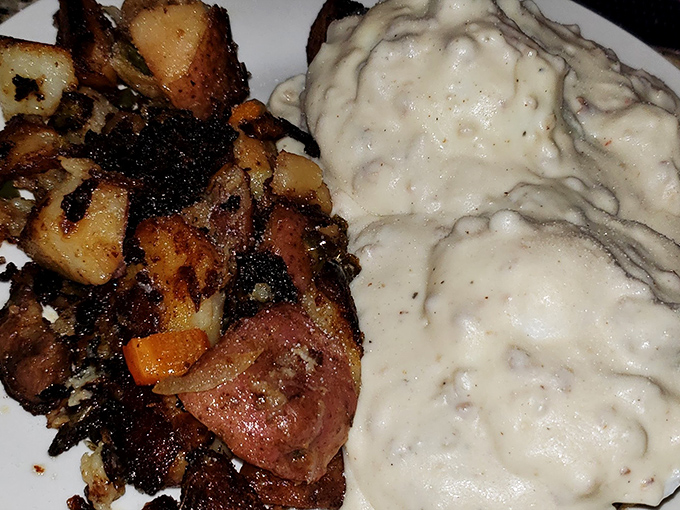 The holy grail of comfort food: biscuits and gravy with a side of crispy home fries. It's like a warm hug for your taste buds.