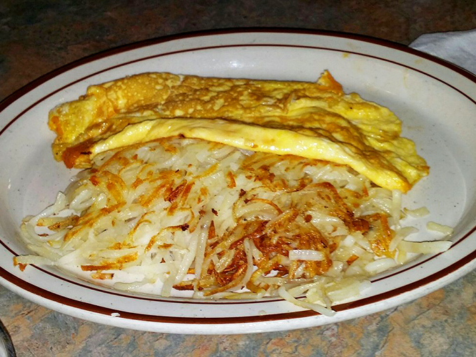 The Cheddar Cheese Omelet: where eggs and cheese perform a delicate ballet. Paired with crispy hash browns, it's a breakfast of champions.