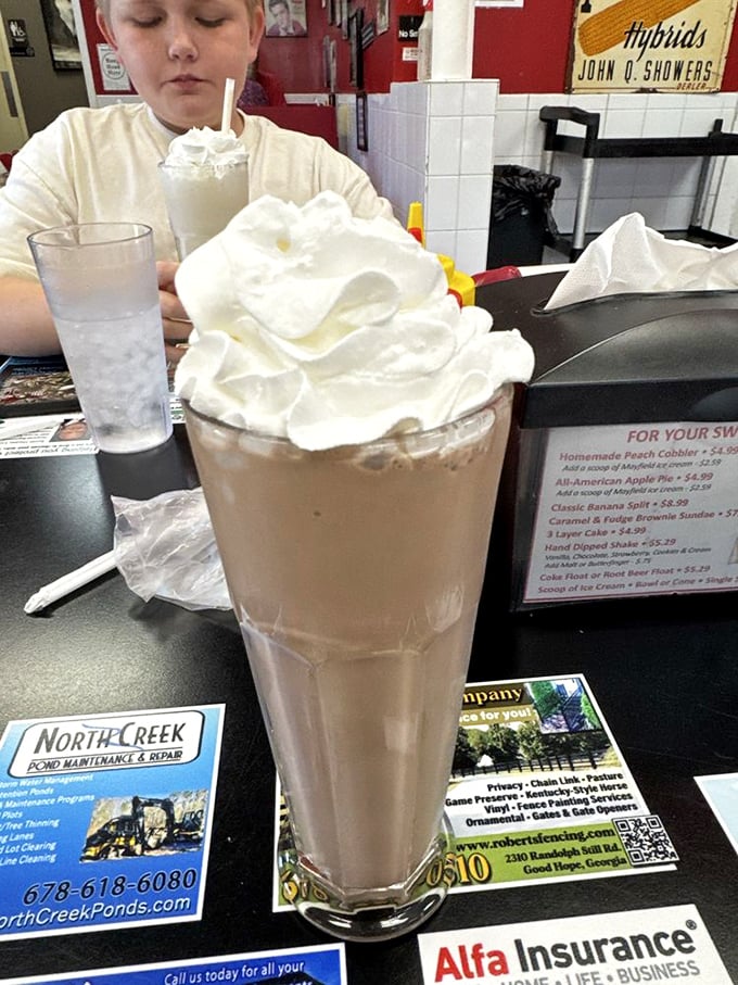 Holy moly, that's not a milkshake—it's a work of art! Topped with enough whipped cream to make a cloud jealous.