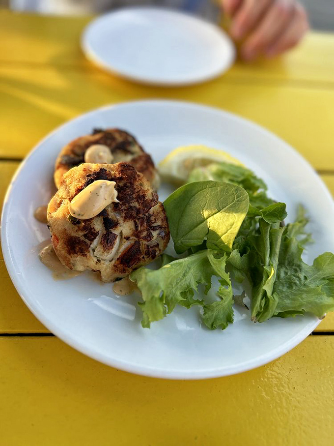 Behold, the star of our show! This crab cake is so perfectly golden and crisp, it could win a beauty pageant for seafood.