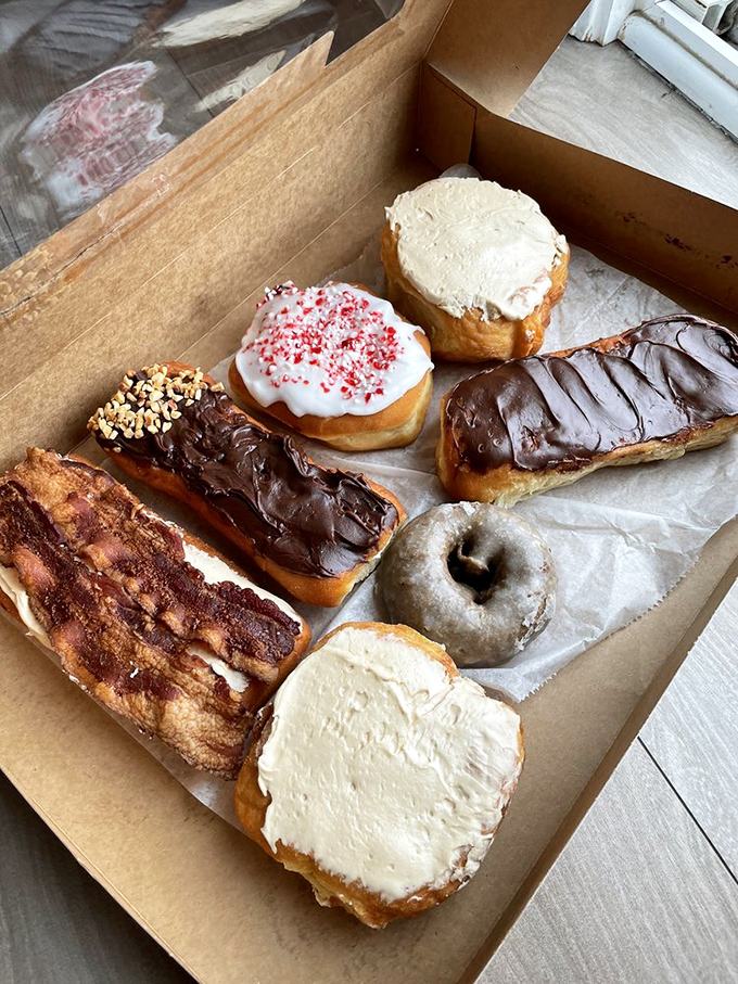 A box of joy, wrapped in paper. These donuts aren't just breakfast; they're an edible art gallery that would make even Homer Simpson weak at the knees.