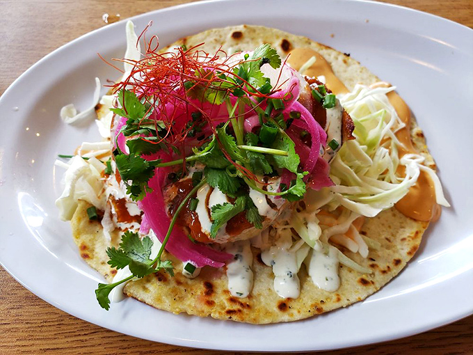 Taco 'bout a flavor explosion! This isn't just a fish taco; it's a fiesta in your mouth, complete with a confetti of fresh toppings.