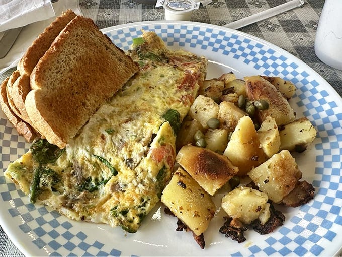 Garden Omelet: Where veggies go to party! This fluffy egg envelope is stuffed with more greens than a salad bar convention.