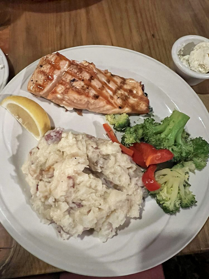 Salmon so perfectly grilled, it might just swim upstream to your plate. And those mashed potatoes? Fluffy clouds of buttery bliss.