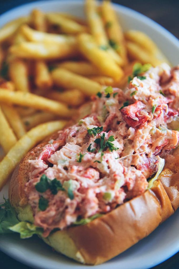 The lobster roll of your dreams! This beauty is so packed with succulent meat, it's like the lobster version of a Kardashian selfie - overstuffed and irresistible.