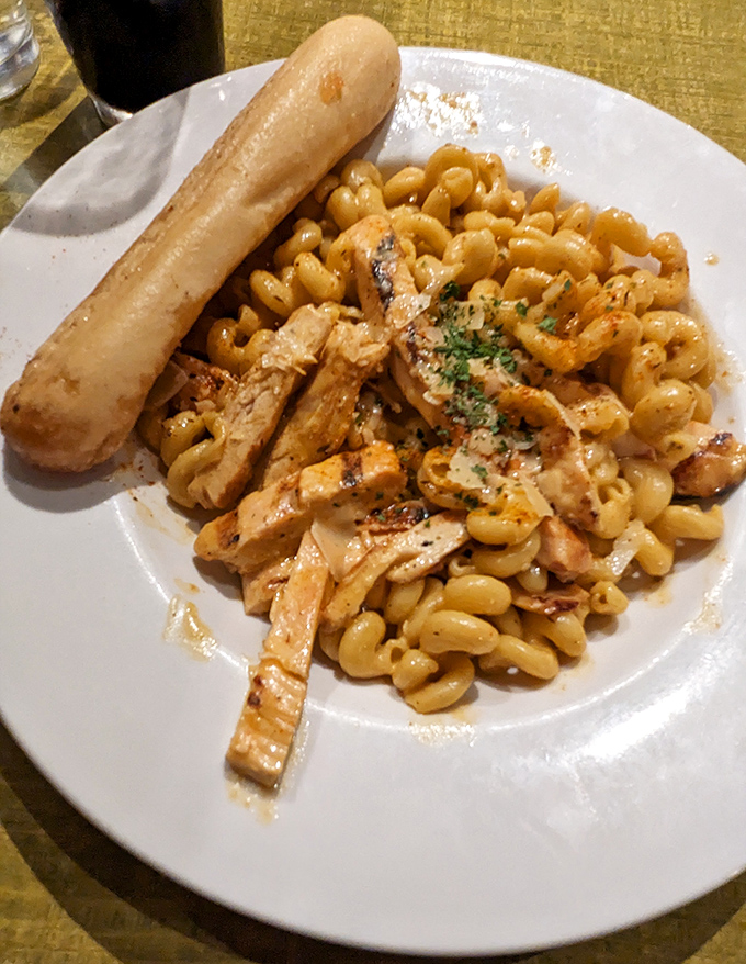 Behold the holy grail of comfort food&mdash;penne pasta embraced by Cougar Gold cheese sauce, with that breadstick standing at attention like a delicious sentinel.