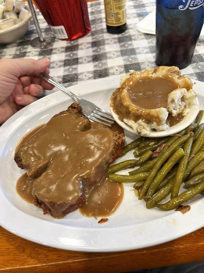 Meatloaf bathed in rich gravy alongside those legendary mashed potatoes&mdash;comfort food that doesn't need a fancy Instagram filter to impress.