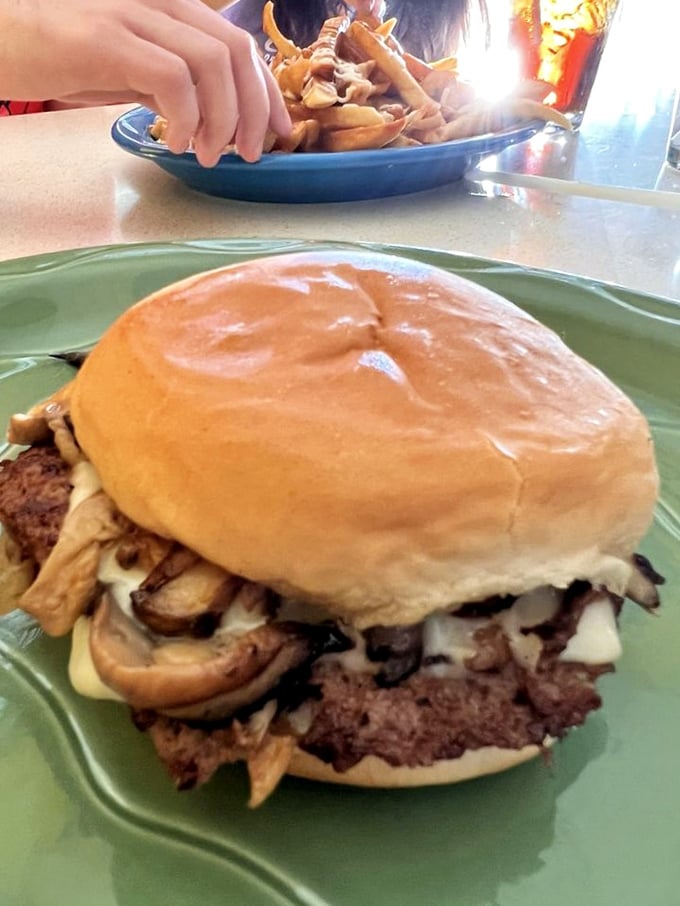 Holy moly, mushroom lovers! This burger is stacked higher than a Jenga tower and twice as likely to make you topple with delight.