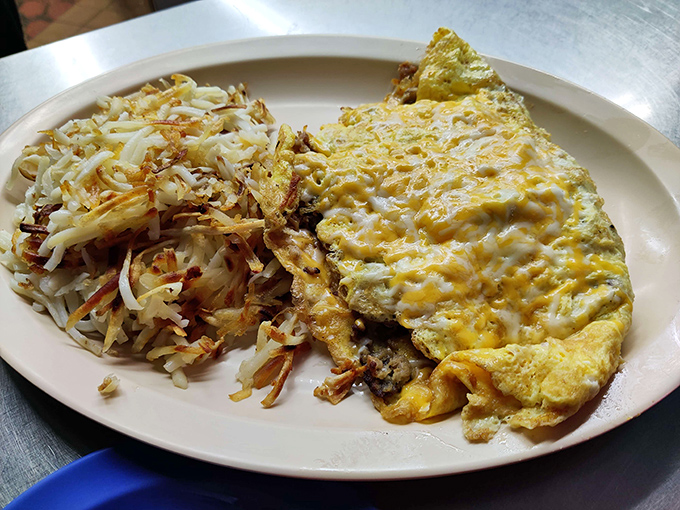 Behold, the omelet that launched a thousand food comas! Paired with hash browns so crispy, they could give potato chips a run for their money.