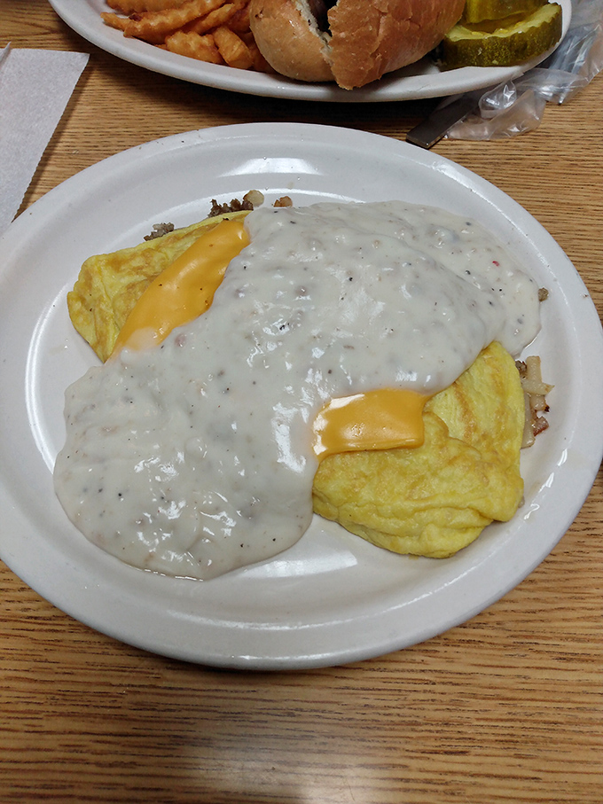 Gravy, oh my! This omelet's taking a luxurious spa day, basking in a creamy, peppery pool of pure comfort.