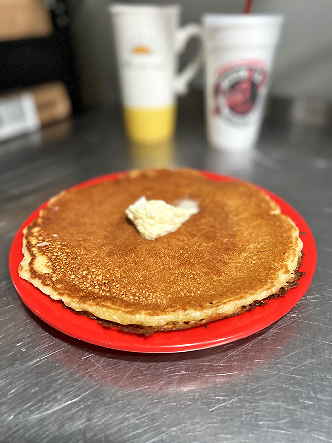 Pancake perfection! This golden disc of joy is so fluffy, it might float away if not for that melty butter anchor.