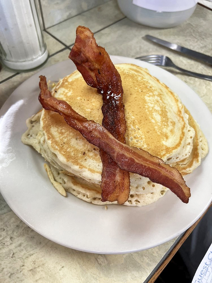 Stack attack! These pancakes are so fluffy, they might float away if it weren't for that crispy bacon anchor. Syrup not included, but highly recommended.