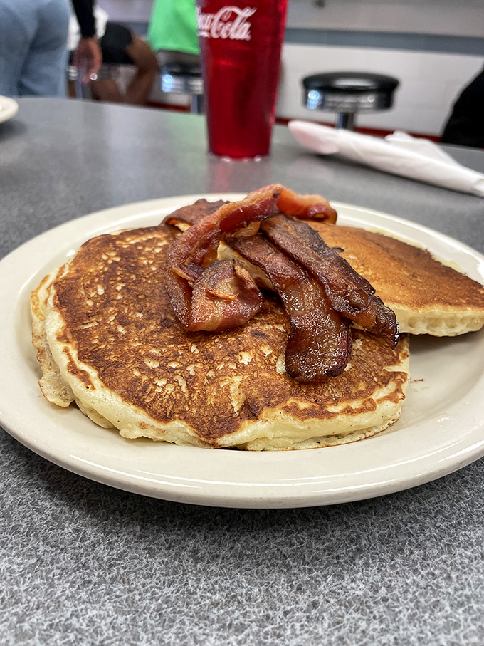 Stack attack! These golden pancakes, crowned with crispy bacon, are the breakfast equivalent of winning the lottery &ndash; deliciously life-changing.