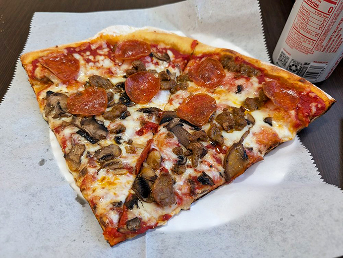 Holy pepperoni! This slice is so loaded, it's like the Avengers of pizza toppings assembled on your plate.