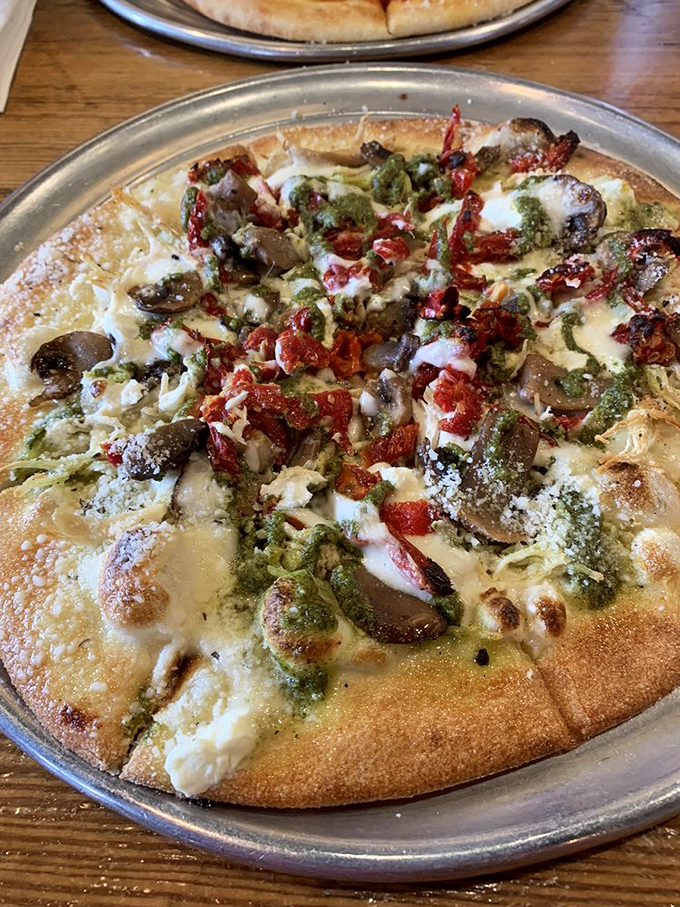 Pesto Chicken Pizza: Where herbaceous green meets golden-brown perfection. It's like springtime decided to throw a party on your taste buds.