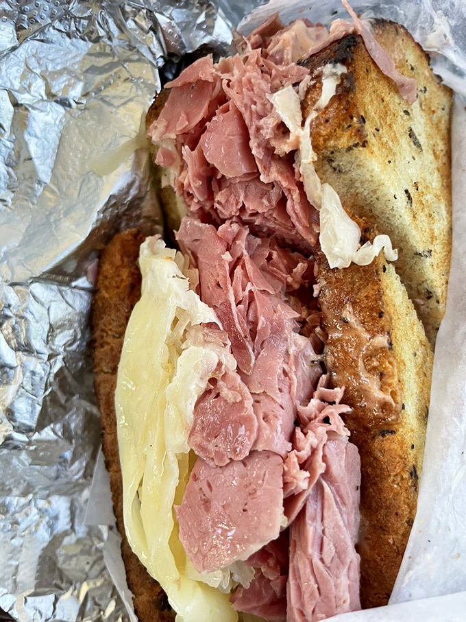 This isn't just a Reuben&mdash;it's an architectural marvel of perfectly stacked corned beef, sauerkraut, and Swiss that demands both hands and your full attention.