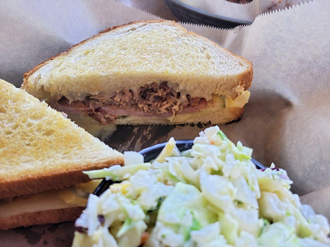 Meet the star of our show: The Reuben. This sandwich isn't just stacked; it's a towering monument to the art of corned beef perfection.