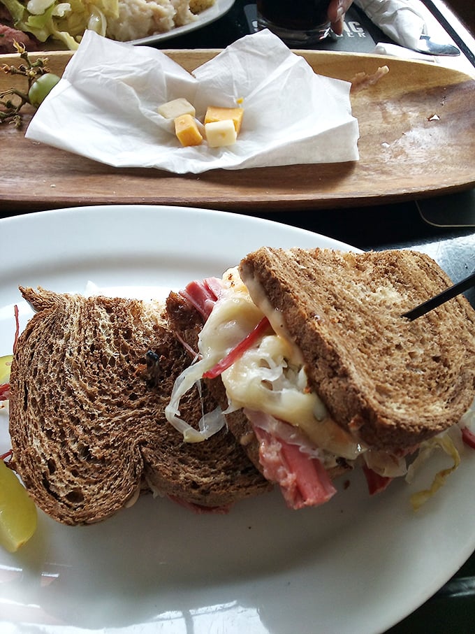 Behold, the Reuben of your dreams! This sandwich is stacked higher than a leprechaun on stilts, promising a flavor explosion with every bite.