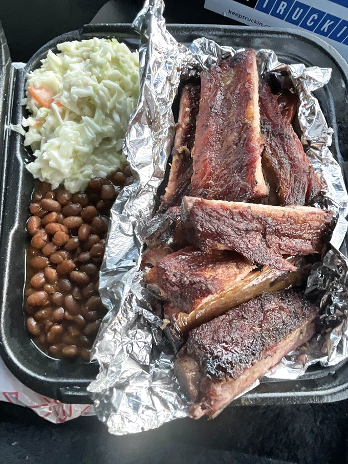 Behold the holy trinity of BBQ: ribs so tender they're falling off the bone, beans that could make cowboys weep, and slaw for that perfect crunch.