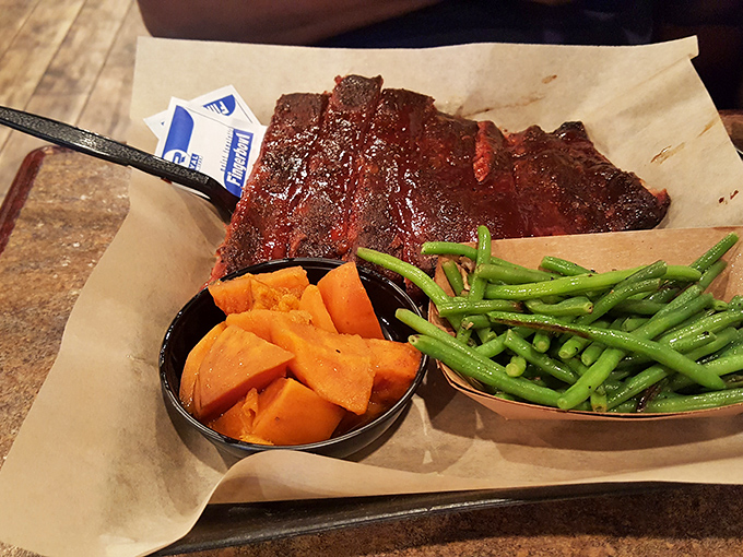 The holy trinity of BBQ bliss! A rack of ribs, golden corn on the cob, and crispy fries &ndash; a meal fit for a king.