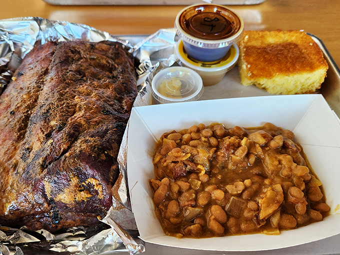 Holy smokes! These ribs look so good, they might just make vegetarians question their life choices. Paired with golden cornbread and beans, it's a plate of pure comfort.