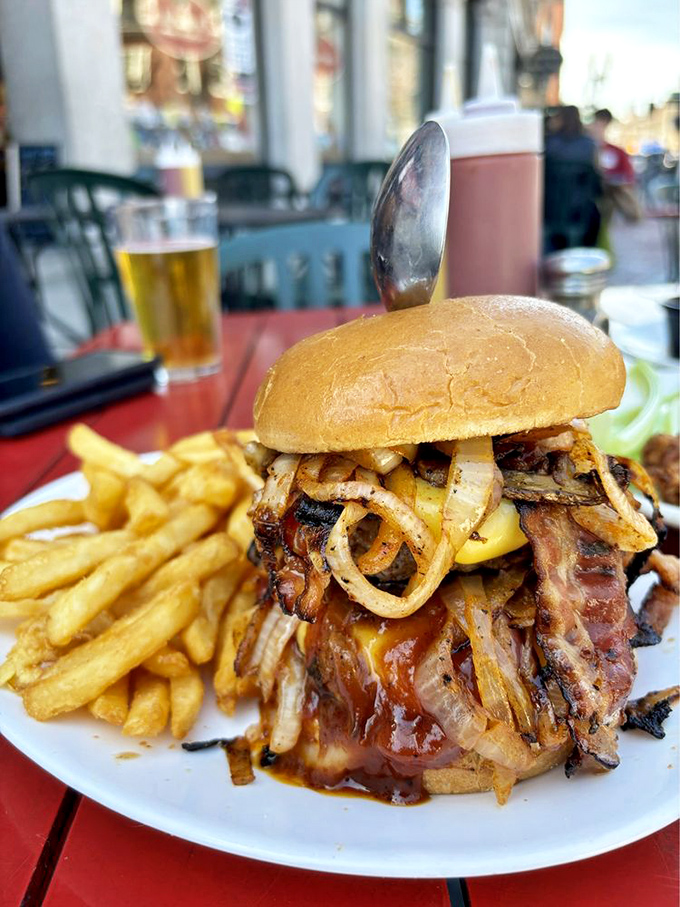 Holy cow! This burger's stacked higher than a freshman's required reading list. It's a tower of flavor that'll make your jaw drop.