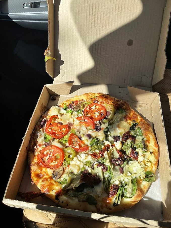 This pizza looks so fresh and vibrant, it's like someone turned a farmers market into a delectable disc of joy.