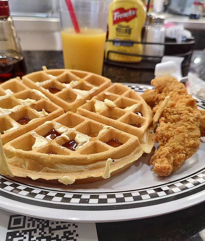 The dynamic duo of diner delights: golden waffles and crispy chicken. It's breakfast and dinner's beautiful love child.