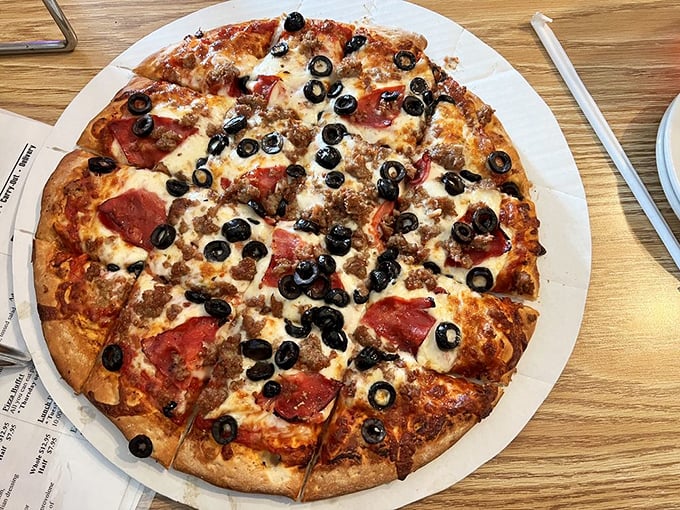 Behold, the pizza of your dreams! This pie is so loaded with toppings, it's like the United Nations of flavors decided to throw a party on your taste buds.