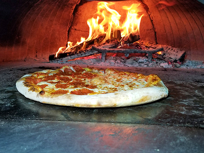 Behold the fiery heart of Mr. P's! This wood-fired oven is where pizza dreams come true, transforming dough into crispy, bubbly perfection.