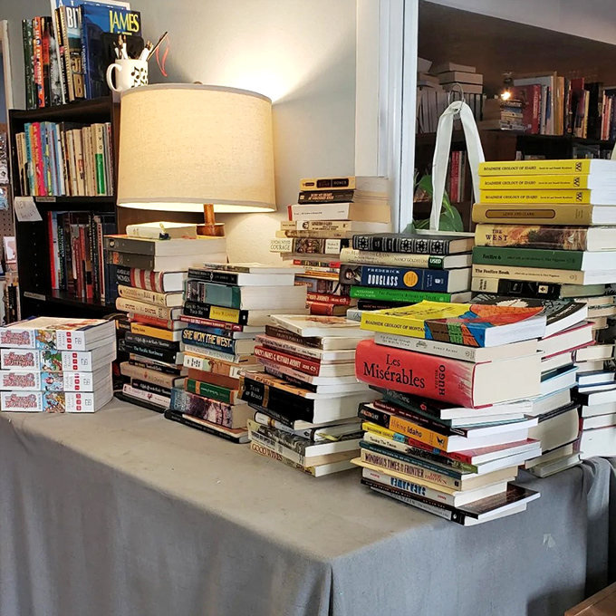 Book towers that would make Jenga champions nervous! This precarious pile of prose is a testament to the store's vast selection.