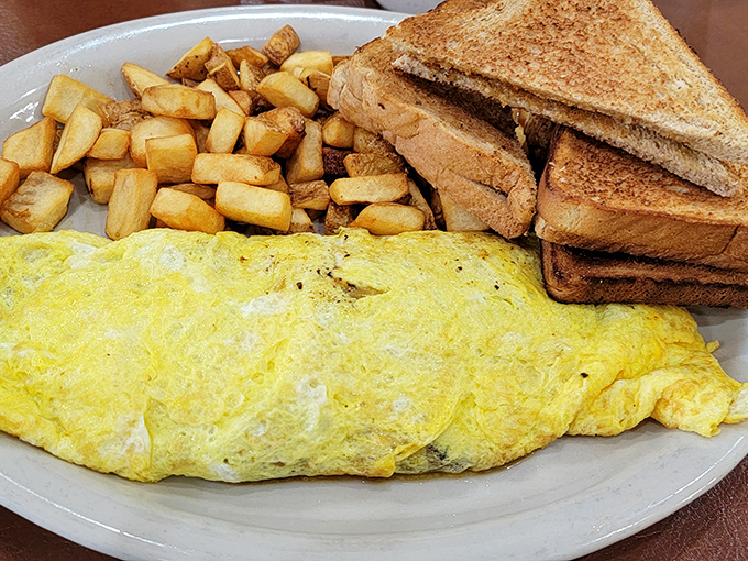 This isn't just breakfast; it's a golden sunrise on a plate. Fluffy eggs, crispy potatoes, and toast that's ready for its close-up.