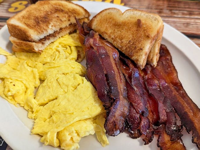 The breakfast of champions... and everyone else! Golden eggs, crispy bacon, and toast that's ready for its close-up.