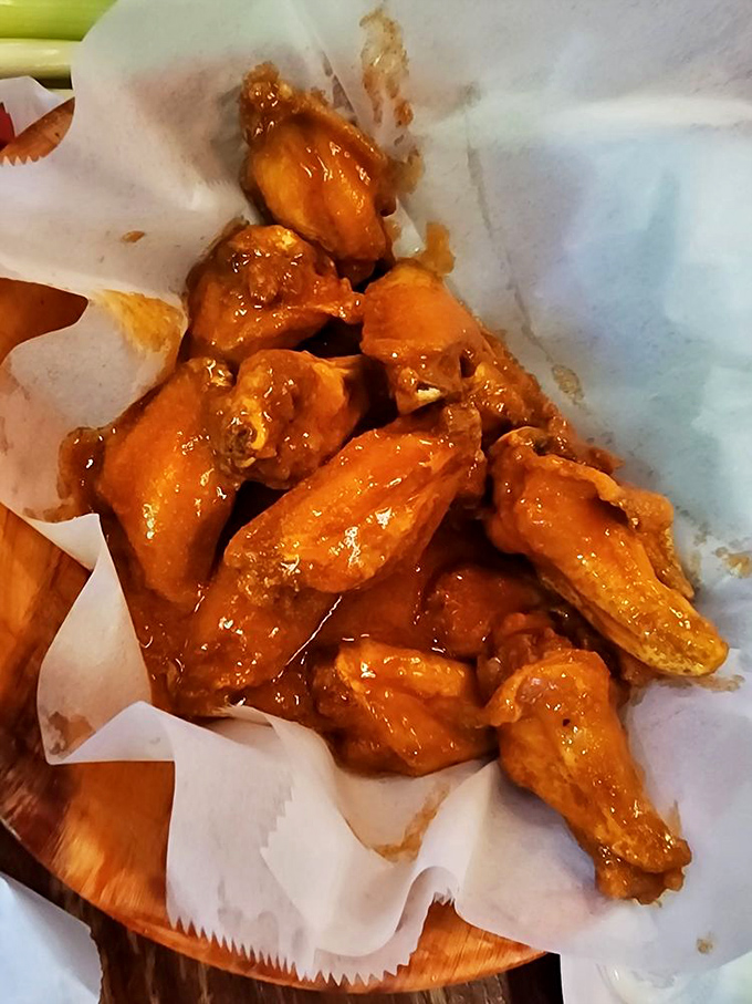 Wings so glistening with sauce they practically wink at you, served unpretentiously on paper&mdash;because some pleasures are too honest to need fancy presentation.