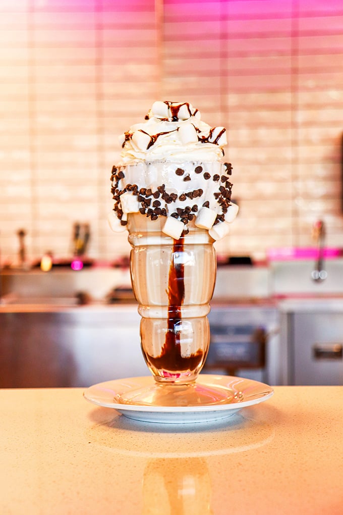 Holy moly, that's not a milkshake &ndash; it's a work of art! Topped with enough whipped cream to make a cloud jealous, this chocolatey masterpiece is pure bliss.