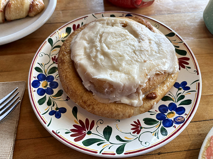 This isn't just any cinnamon roll - it's a cloud of sweet, pillowy perfection crowned with a generous swirl of cream cheese frosting.