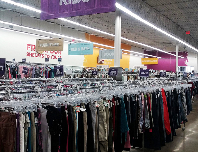 Color-coded clothing racks stretch toward the horizon like a textile rainbow. The "KIDS" section alone could outfit every school play in Montgomery County.