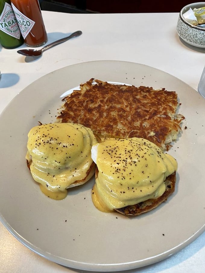 Eggs Benedict done right &ndash; two perfectly poached eggs nestled on English muffins, draped in hollandaise, with hash browns crisped to golden perfection.