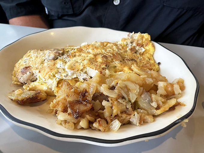 Eggs-cellent choice! This feta omelet is a fluffy cloud of breakfast bliss, paired with golden home fries that could make a potato proud.