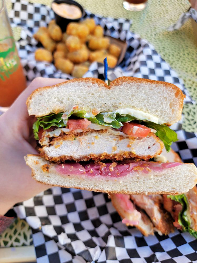 This isn't just a sandwich; it's a tower of flavor! Crispy chicken, fresh veggies, and a bun so perfect, it could star in its own cooking show.