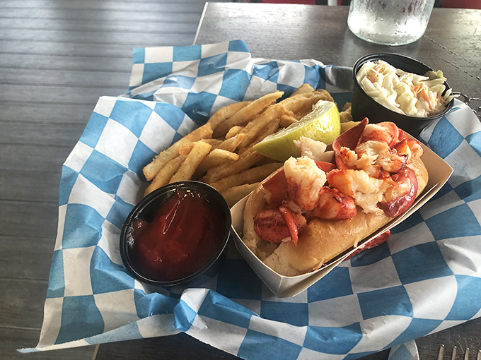 Behold, the lobster roll of your dreams! It's so packed with succulent meat, you'll wonder if they've been secretly breeding giant lobsters.