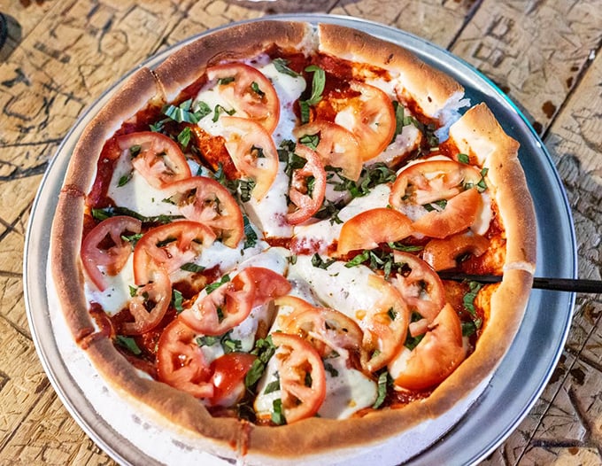 Fresh from the oven, this margherita pizza is a canvas of flavor that would make even the Mona Lisa smile.