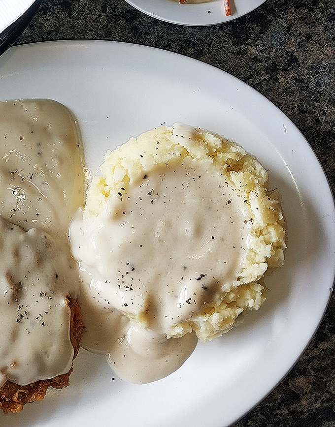 Behold: the mashed potato volcano with its gravy lava flow. Scientists should study how something so simple can trigger such profound joy.