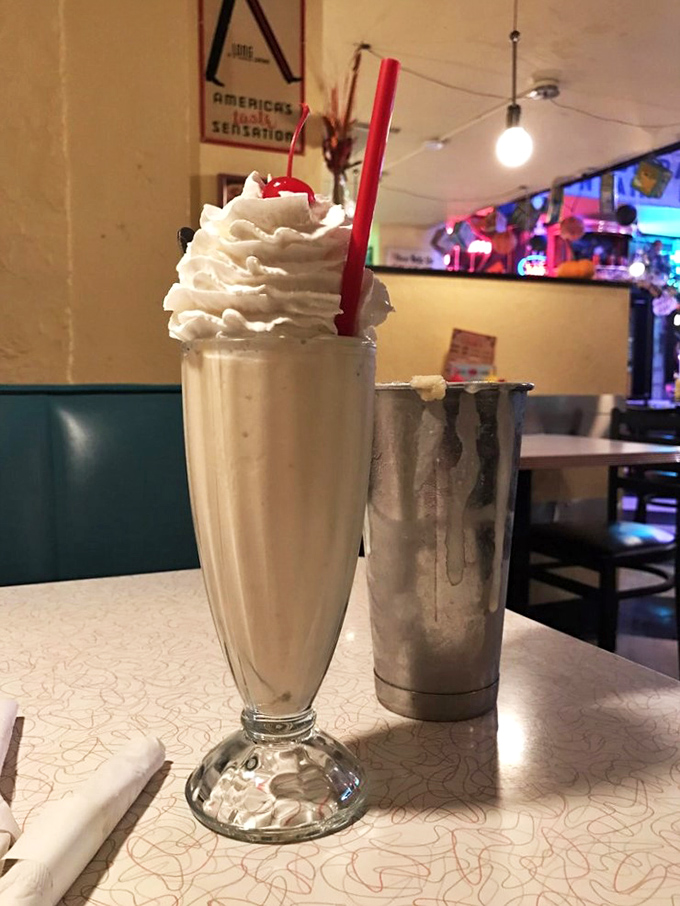 Behold, the milkshake of your dreams! Topped with a mountain of whipped cream, it's a dairy lover's Everest waiting to be conquered.
