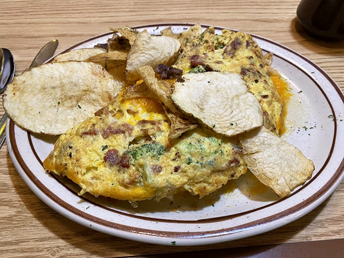 Behold, the omelet of champions! This fluffy masterpiece is so packed with goodies, it's practically doing bicep curls on your plate.