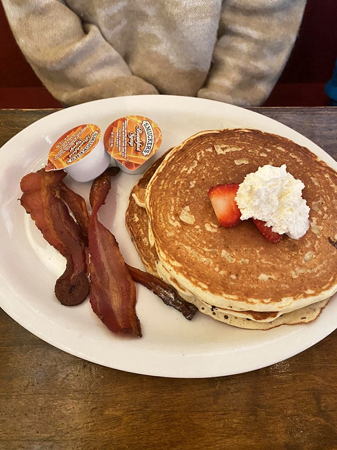 Pancakes that could make IHOP jealous. These fluffy stacks are ready for their syrupy close-up, with bacon playing a crispy supporting role.