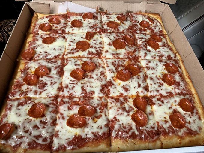 Pepperoni perfection! This square slice is like a cheesy, saucy chessboard where every move is delicious.