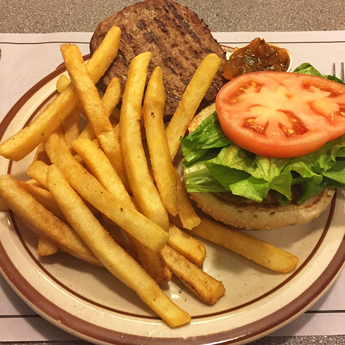 Behold the Pit Deluxe Special! It's not just a burger; it's a towering testament to the art of stacking deliciousness between two buns.