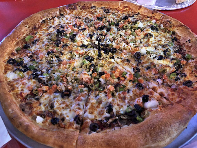 Holy toppings, Batman! This pizza is loaded with more goodies than the Batcave. A true superhero of the pizza world.