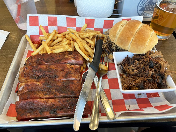 Holy smokes, Batman! This platter's not just a meal, it's a meaty masterpiece. Ribs, pulled pork, and fries &ndash; oh my!